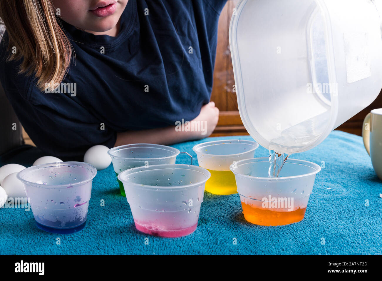 Pouring water into tubs for easter egg dyeing Stock Photo - Alamy