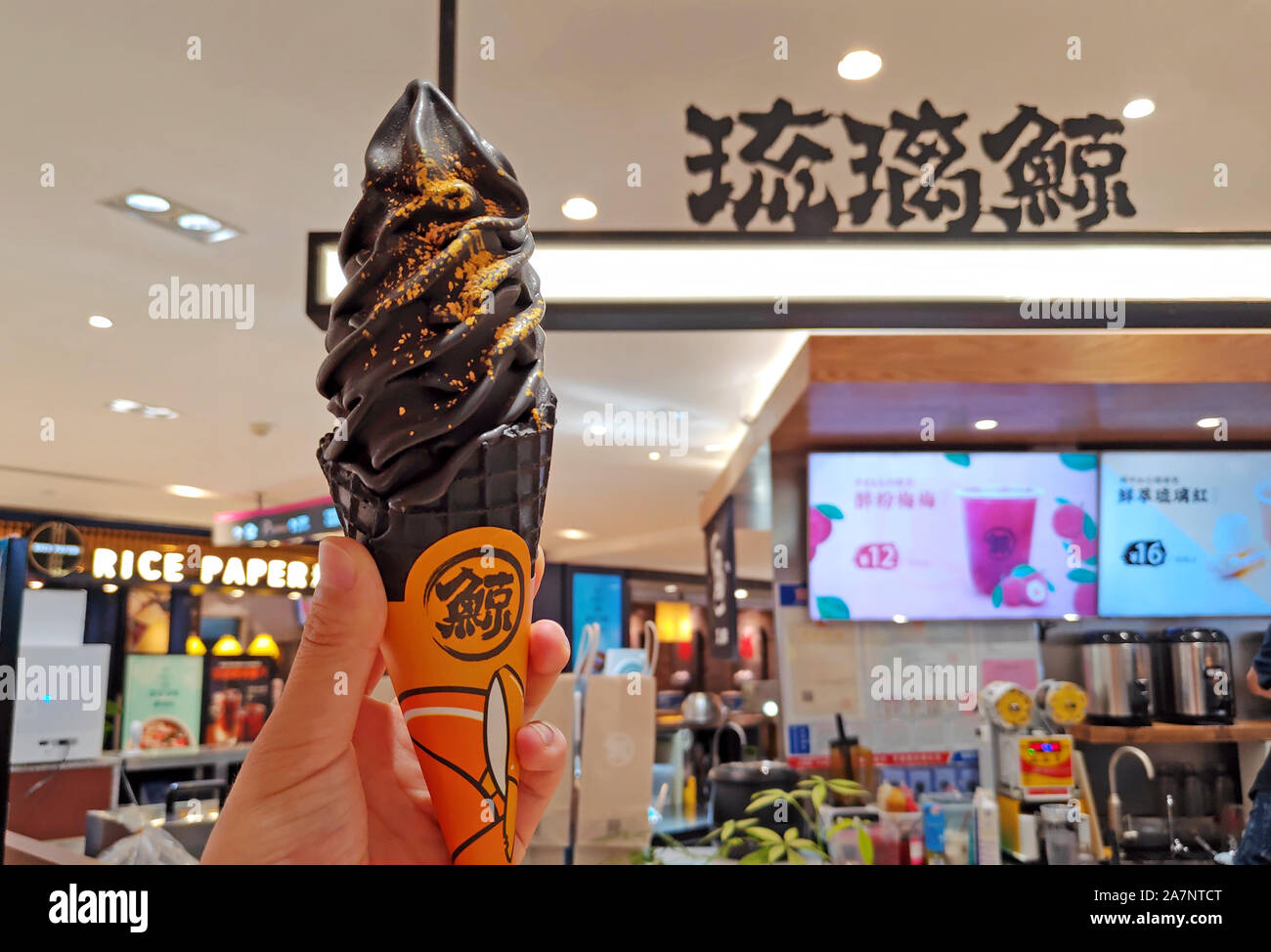 A Chinese customer shows an ice cream cone featuring Wuliangye baijiu ...