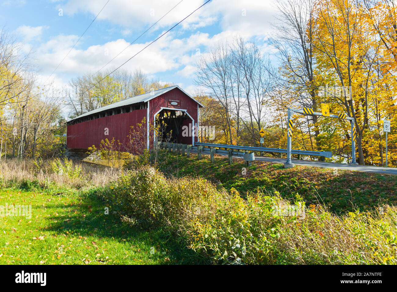 Covered bridge in Quebec (Canada). Timber-truss bridge with a roof ...