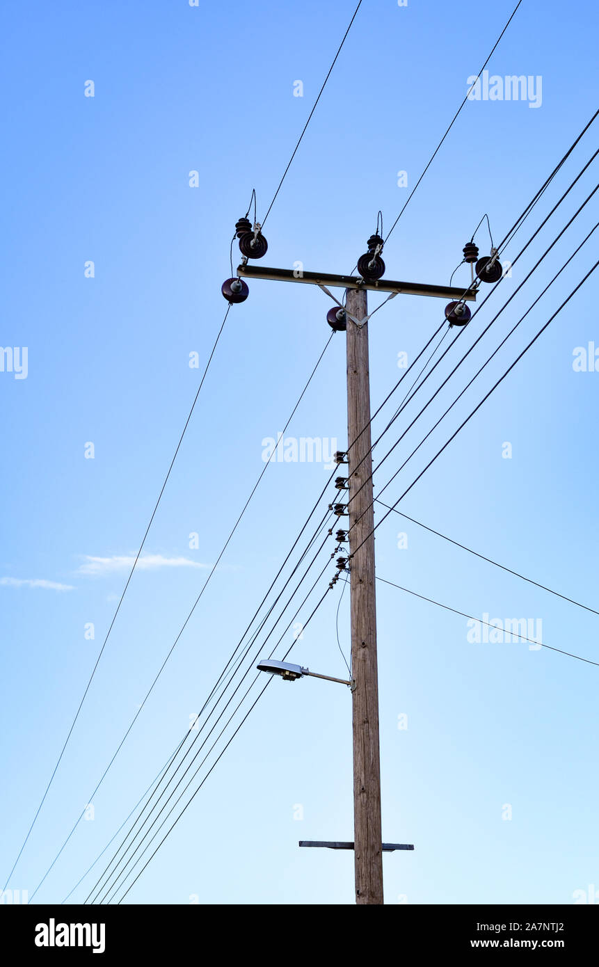 Low angle view of wooden electricity pylon against clear blue sky Stock ...