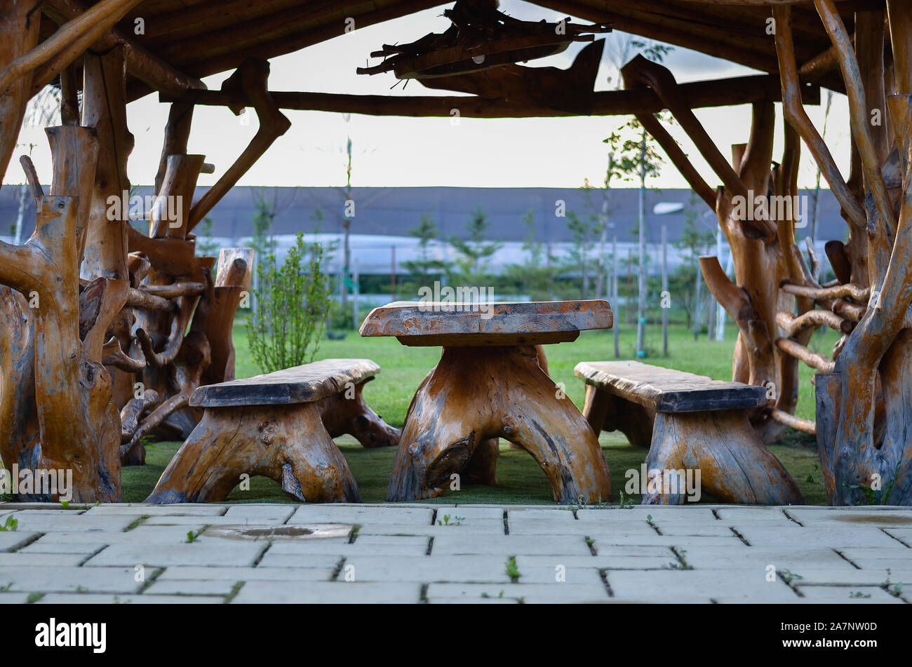Rustic terrace with table and chairs made of natural wood parts in ...