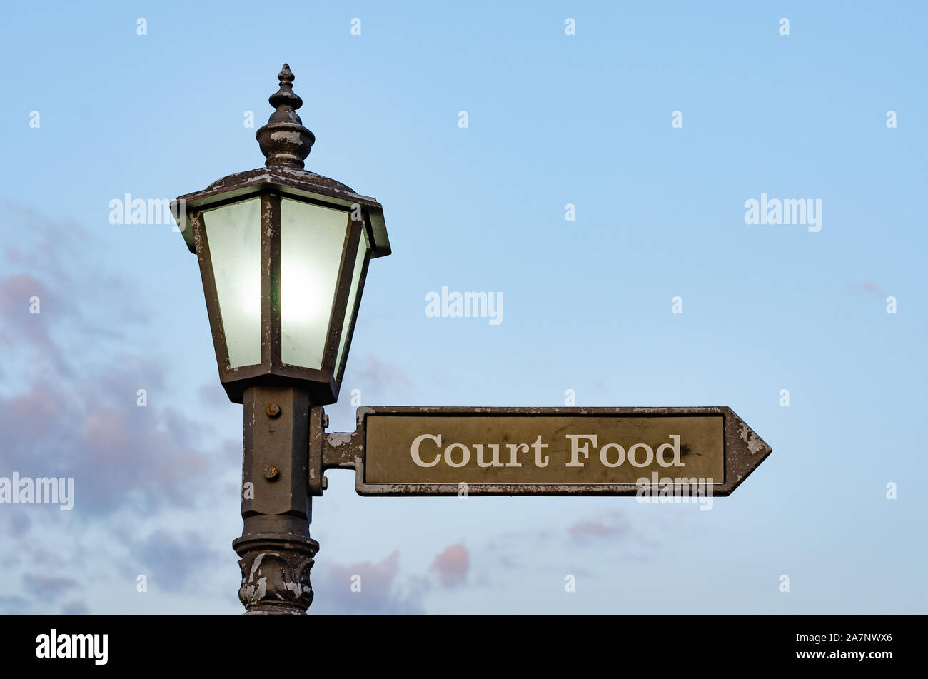 Close-up of street lighting pole with iron sign to the food court Stock ...