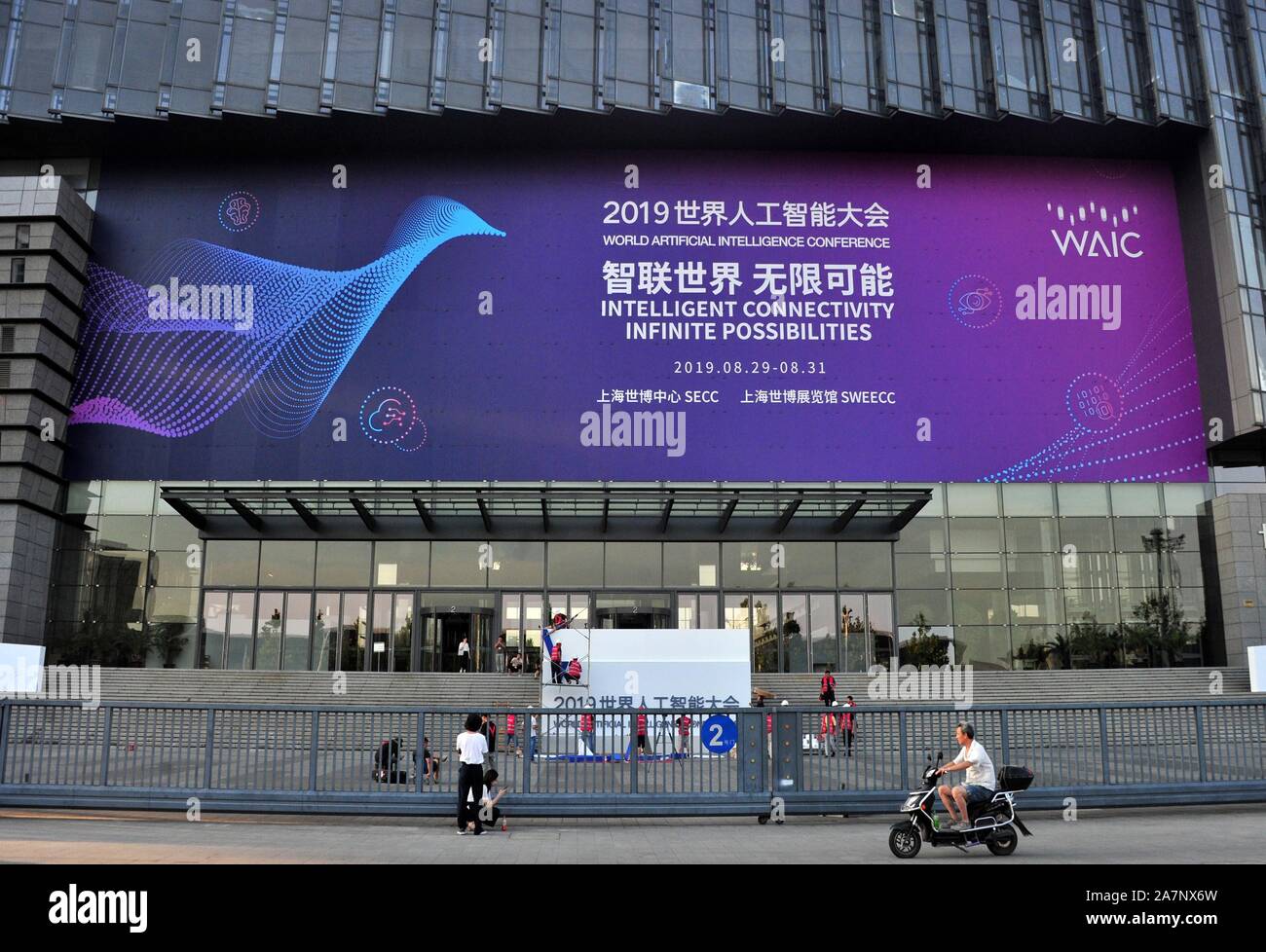 Chinese workers prepare for 2019 World Artificial Intelligence Conference (WAIC) at the Shanghai ...