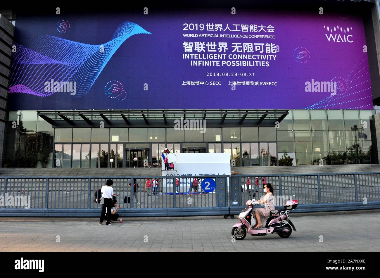 Chinese workers prepare for 2019 World Artificial Intelligence Conference (WAIC) at the Shanghai ...