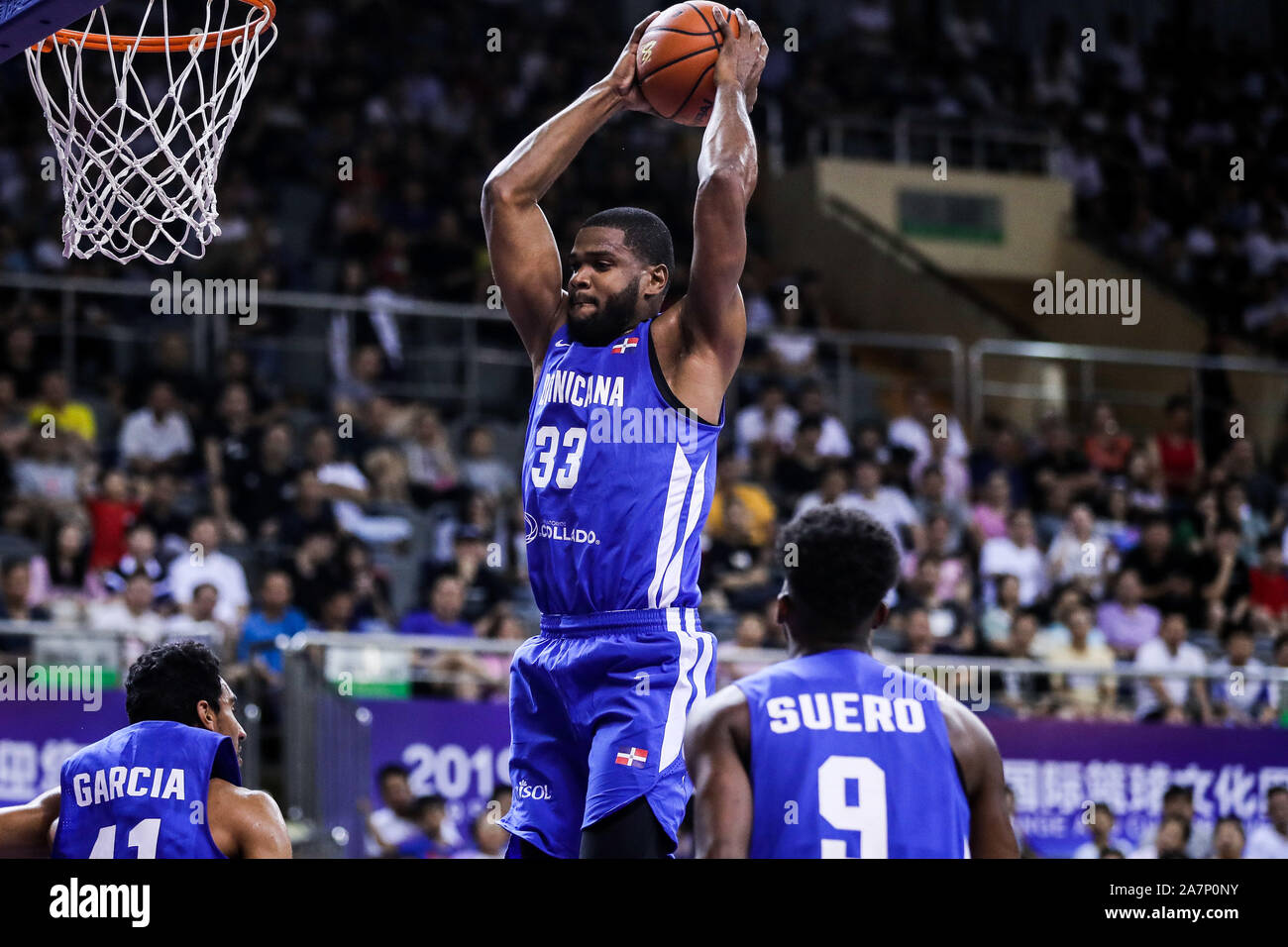 A member of Dominica basketball team, middle, jumps to dunk during 2019 ...