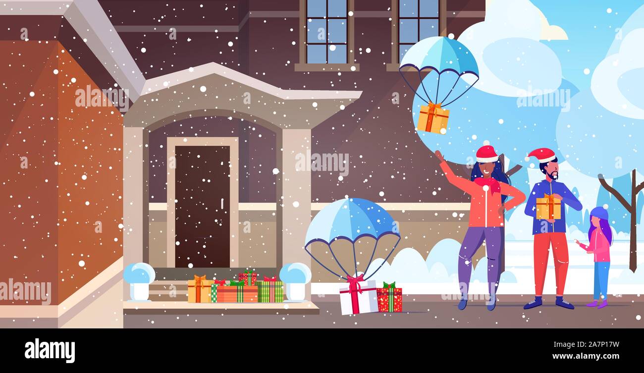 family catching gift present boxes falling down with parachutes merry ...
