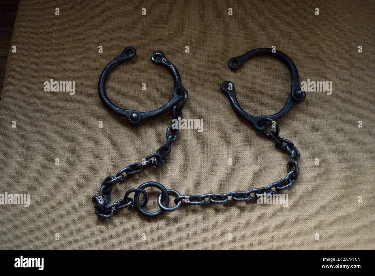 Set of metal manacles on a plain background Stock Photo - Alamy