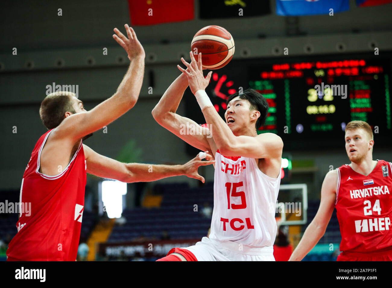 Zhou Qi, a professional Chinese basketball player, middle, jumps for a ...