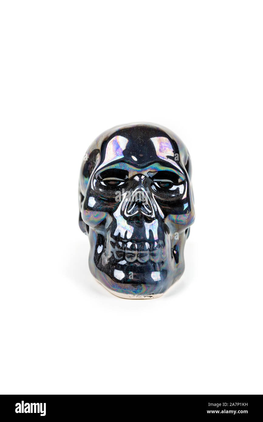 Black shiny ceramic skull figures on a blank background Stock Photo - Alamy