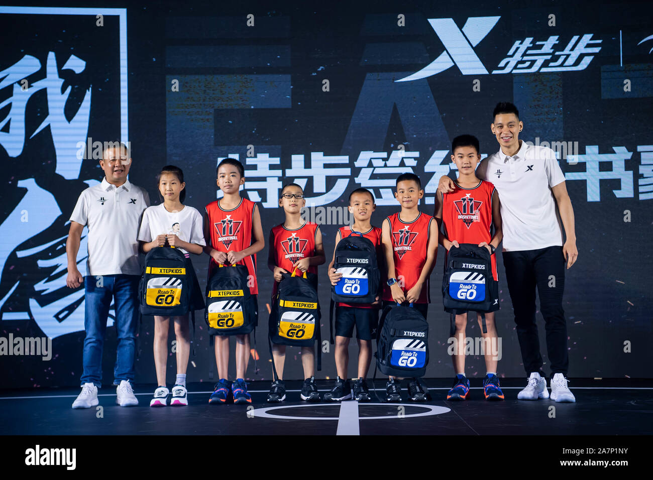Jeremy Lin, the first from right, poses to take photos in Guangzhou ...