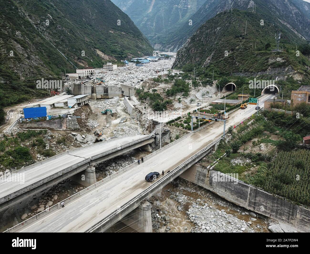 Aerial view of collapsed viaduct and overturned truck due to mudslide ...