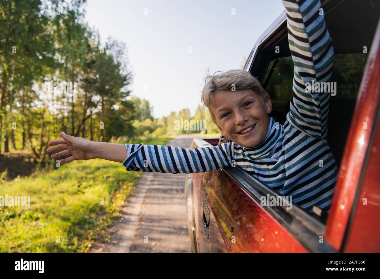 Happy kid travel by the car. He popped out of the window Stock Photo ...