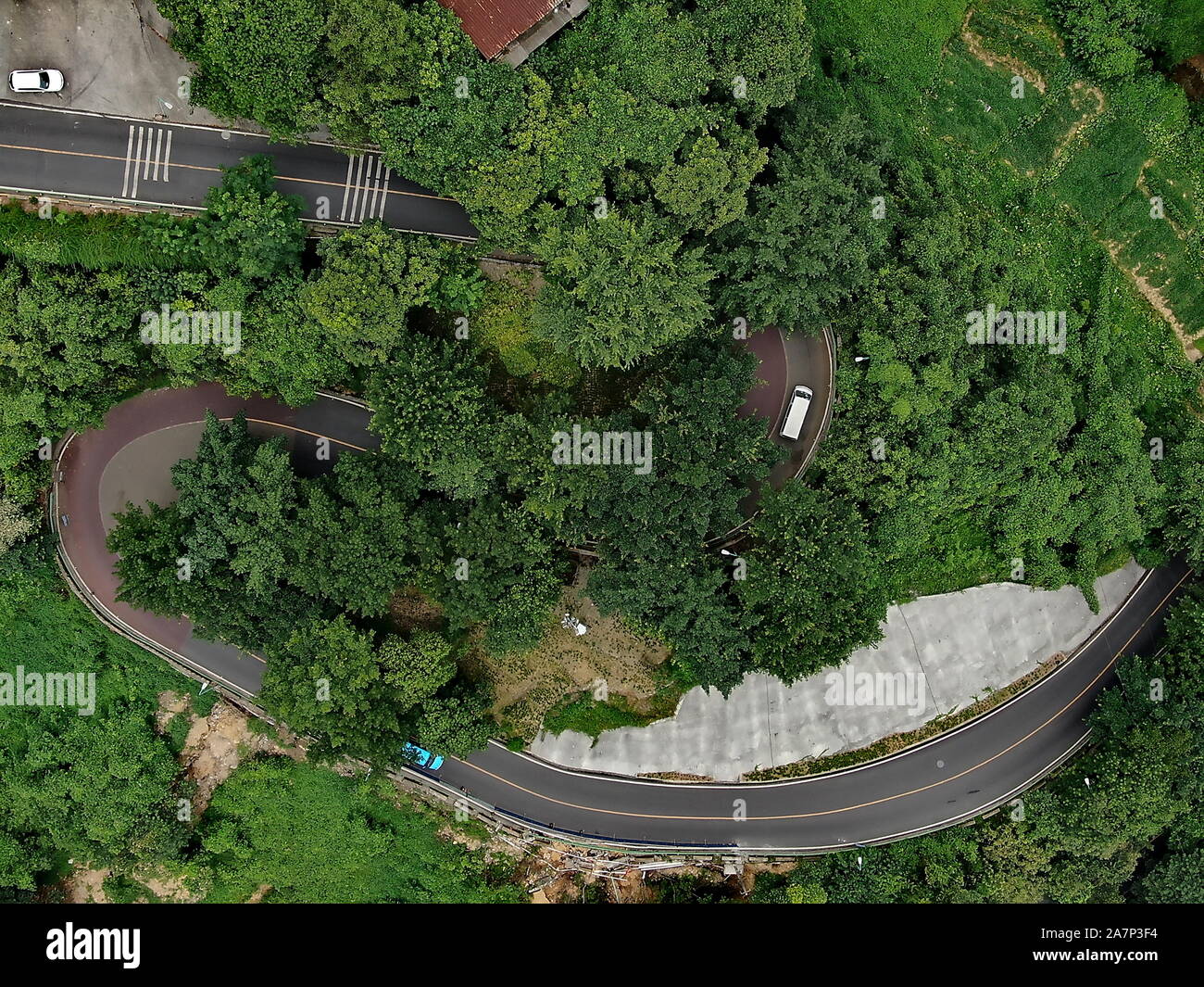 Aerial view of a winding mountain road with 5 curves around mountains ...