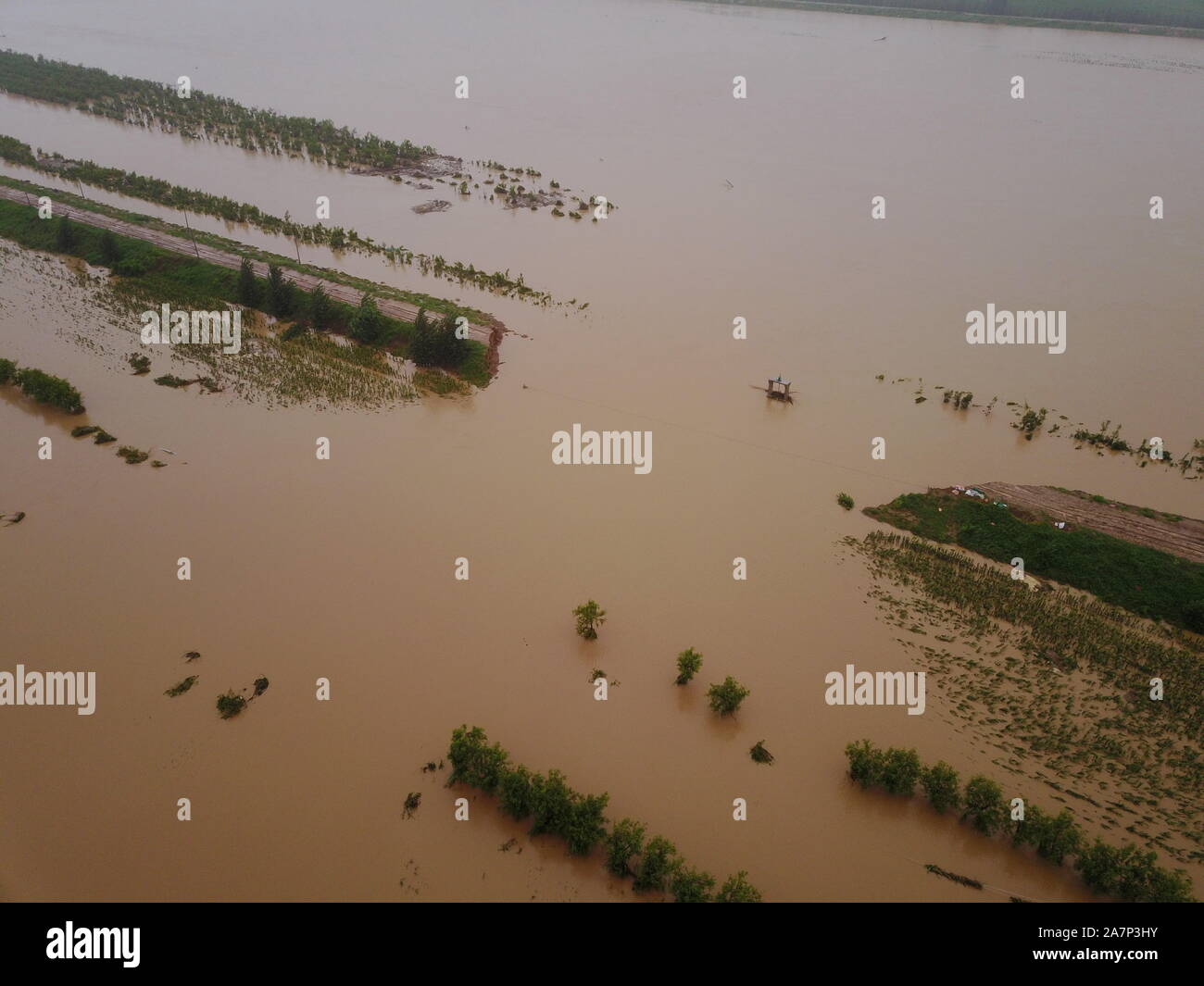 Aerial view of fields submerged by floodwater after heavy rainstorm ...
