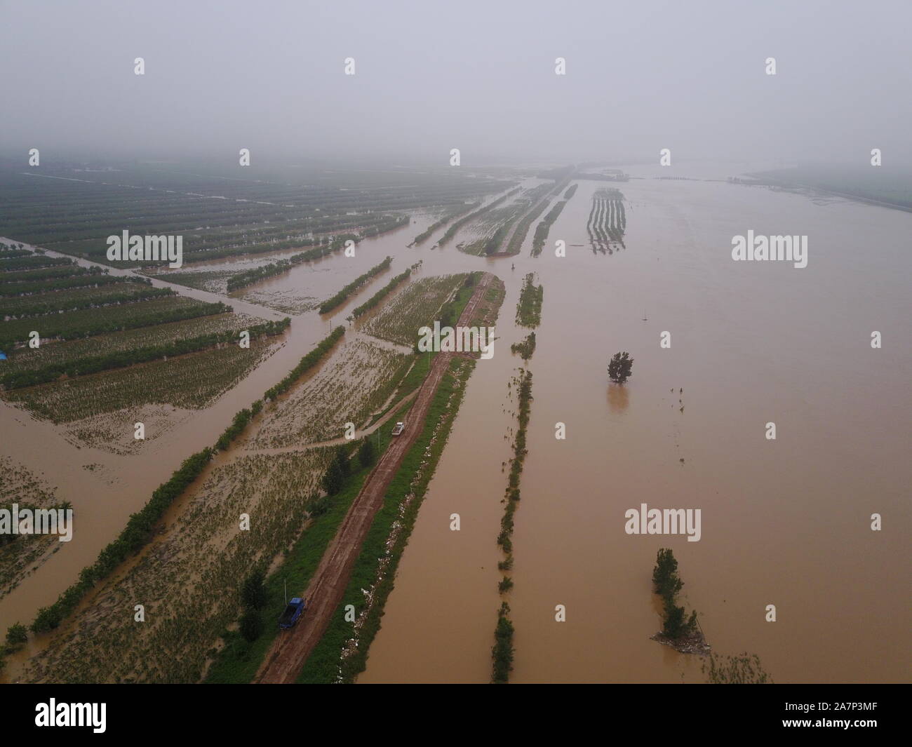 Aerial view of fields submerged by floodwater after heavy rainstorm ...