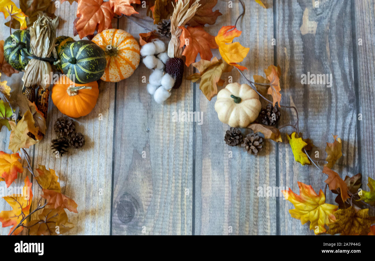 Autumn Background with leaves, pumpkins, and gourds on a wood ...