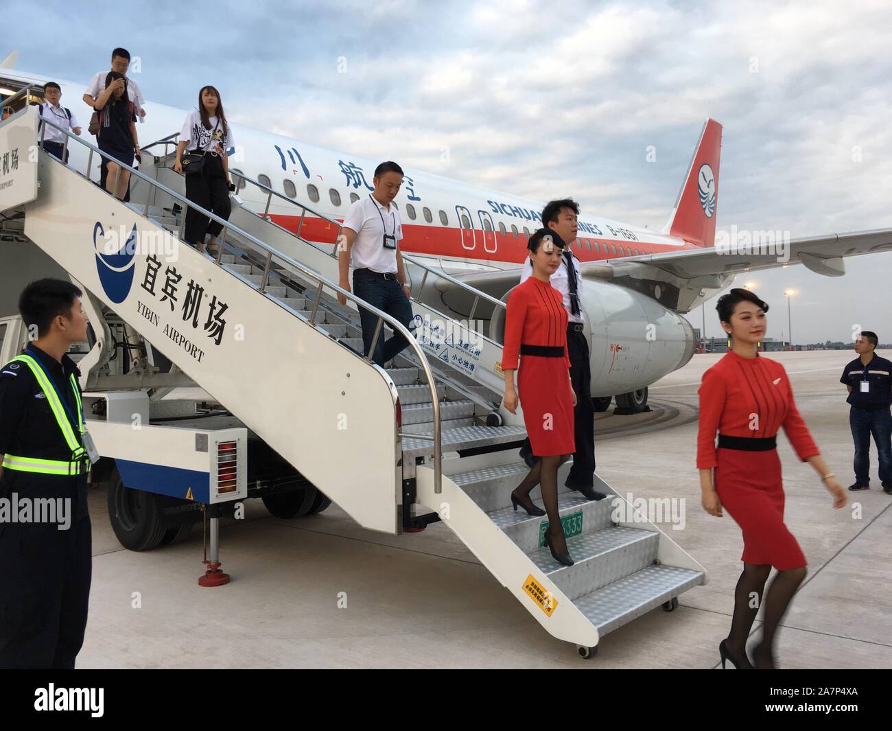 The crew of the Airbus A320 from Chengdu step out of the plane at Yibin ...
