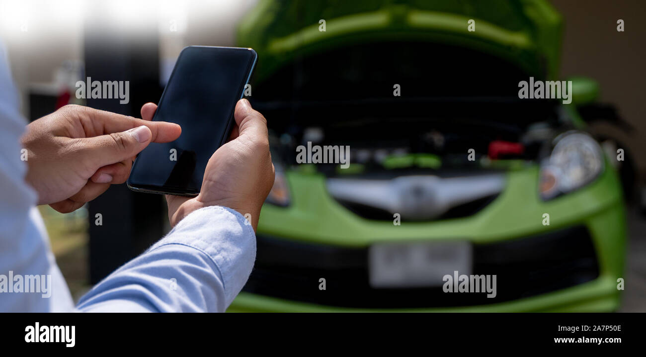 man Using a mobile phone call to assistance Help with a broken down car ...