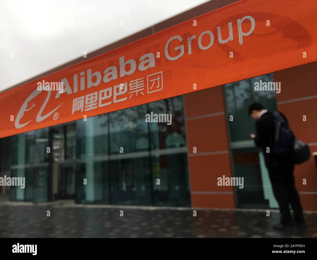 --FILE--An employee walks towards an office building of Alibaba Group ...
