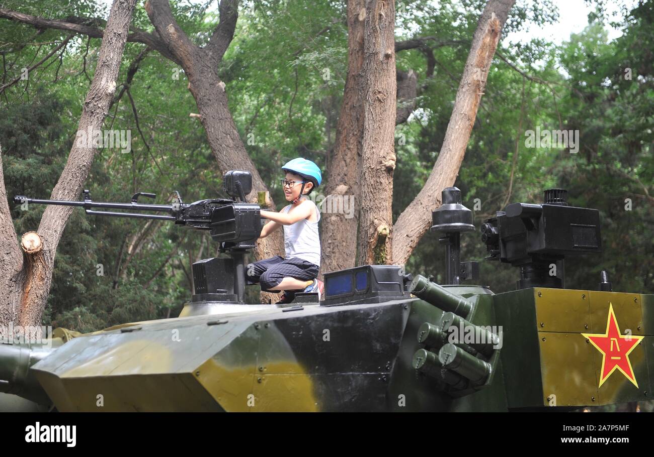 Citizens pose to photo with warcraft, tank, machine gun and other army ...