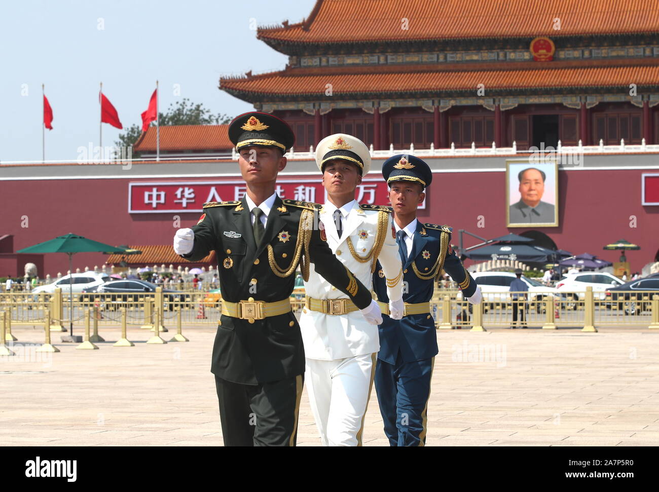 A soldier, a sailor and an airman patrol at the Tian'anmen Square to ...
