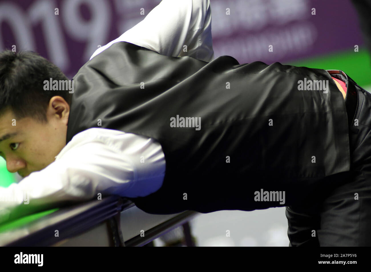 Ding Junhui of China plays a shot to Mark Allen of Northern Ireland in ...