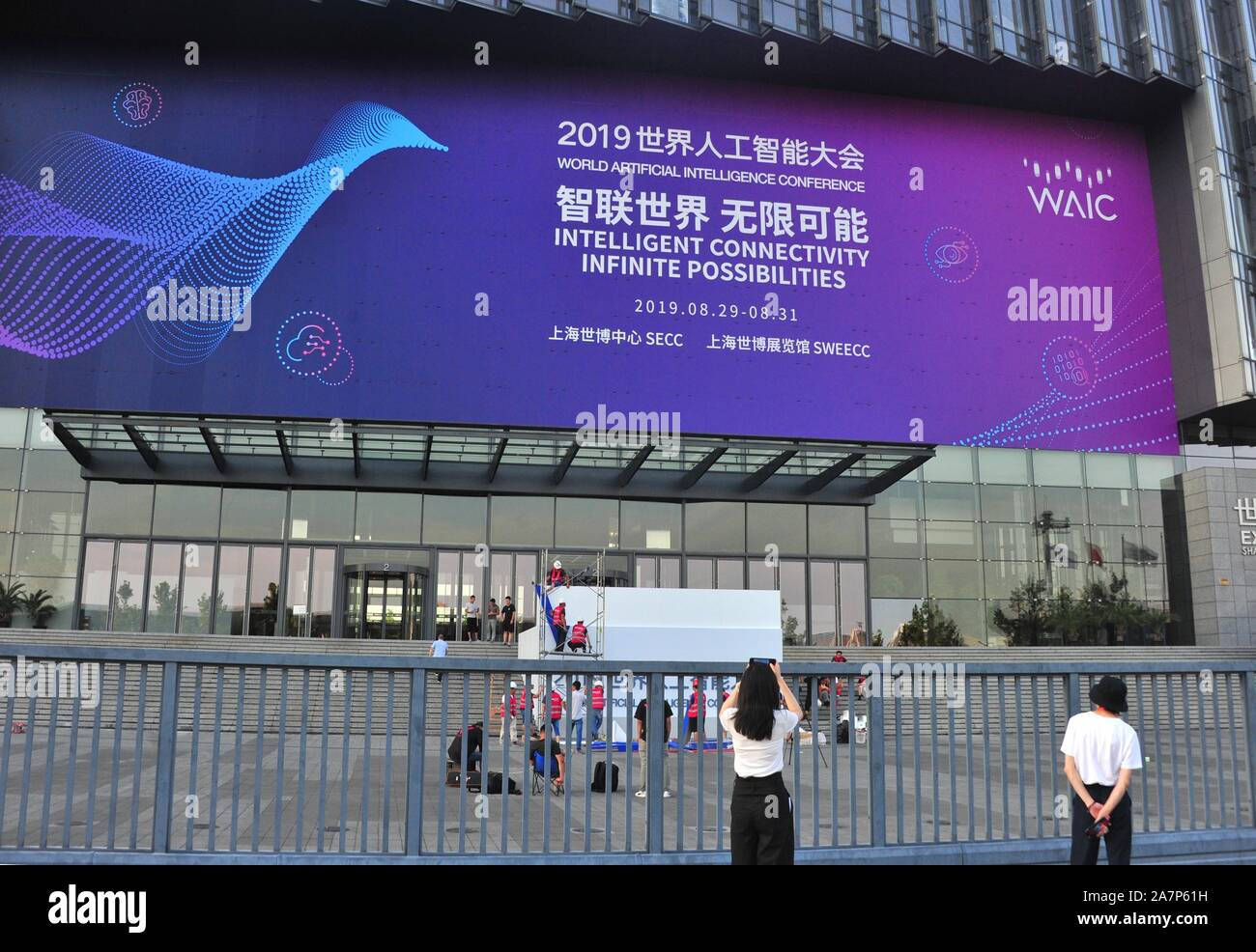 Chinese workers prepare for 2019 World Artificial Intelligence Conference (WAIC) at the Shanghai ...