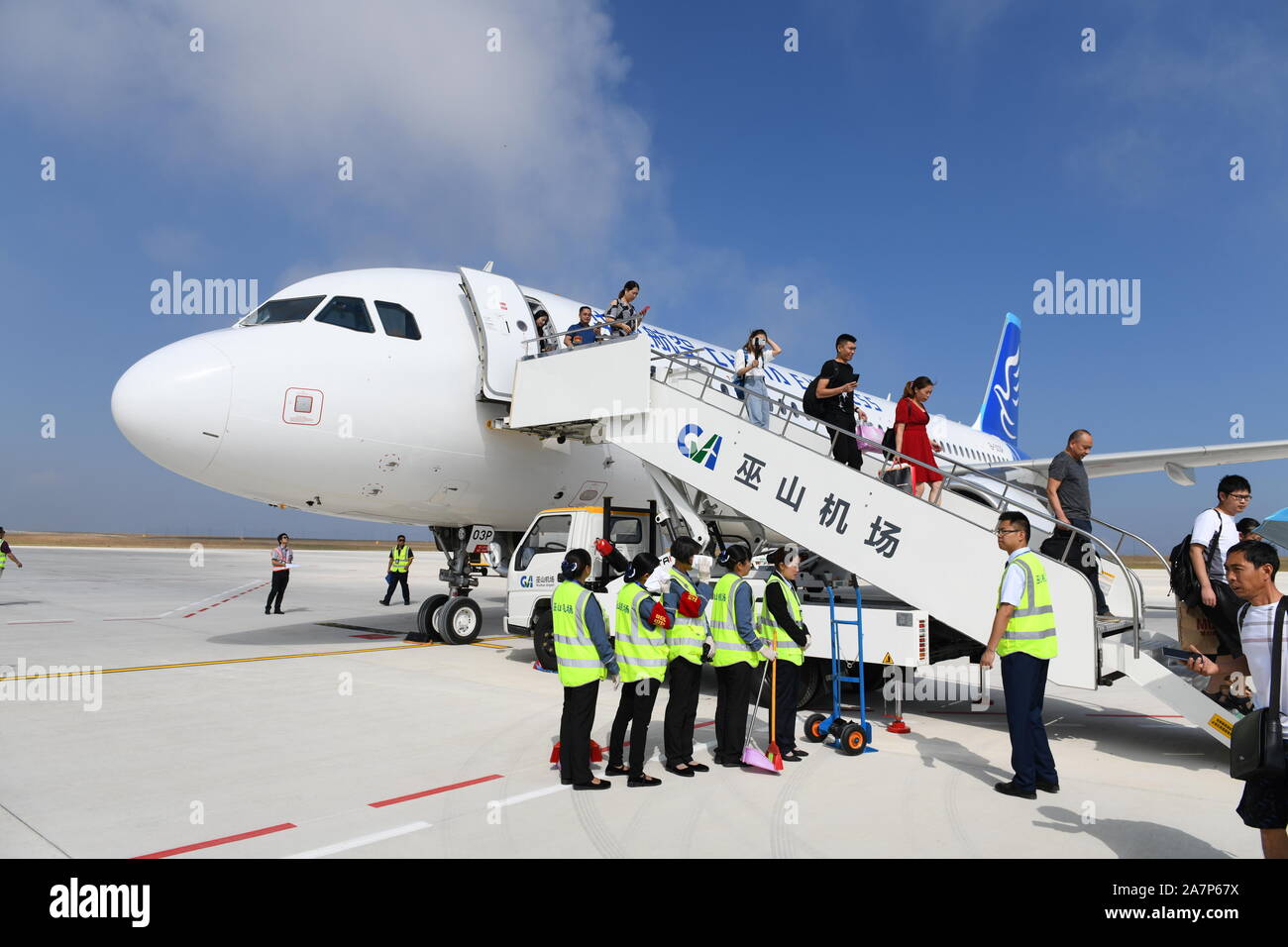 Passengers wait to board a jet plane of China Express at the Chongqing ...