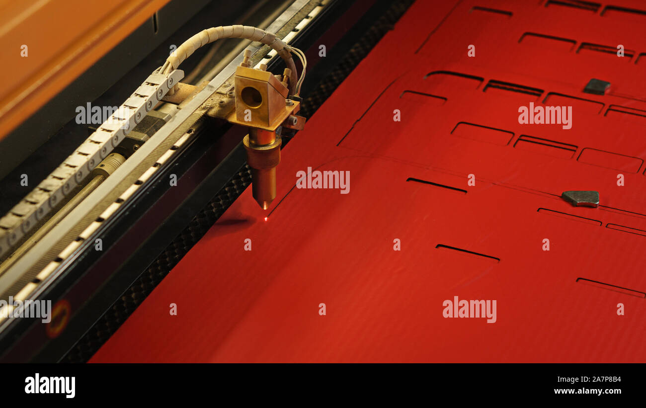 Laser cutting beam high precision on a paperboard. Modern machine ...