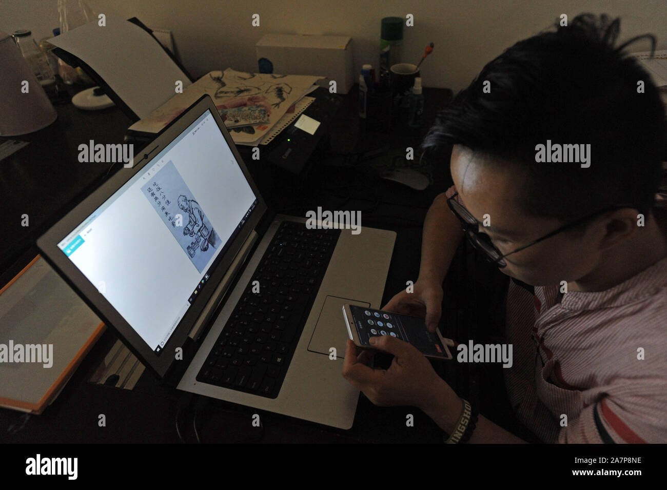 Wangrui is working in the shared kitchen he set up next to the Medical ...