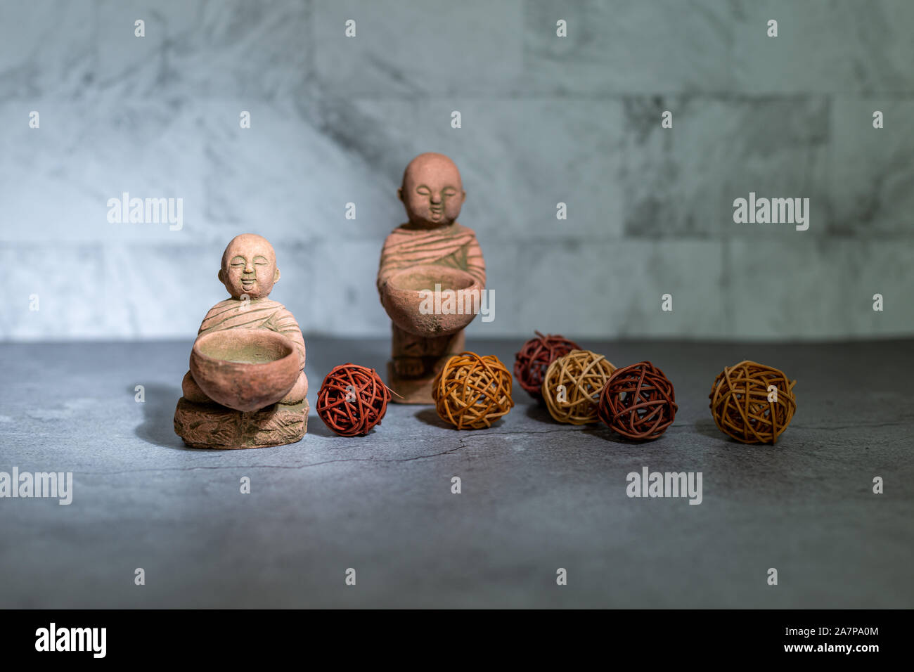 Home decoration ornament. Two little monk statue standing. Rattan cane ...