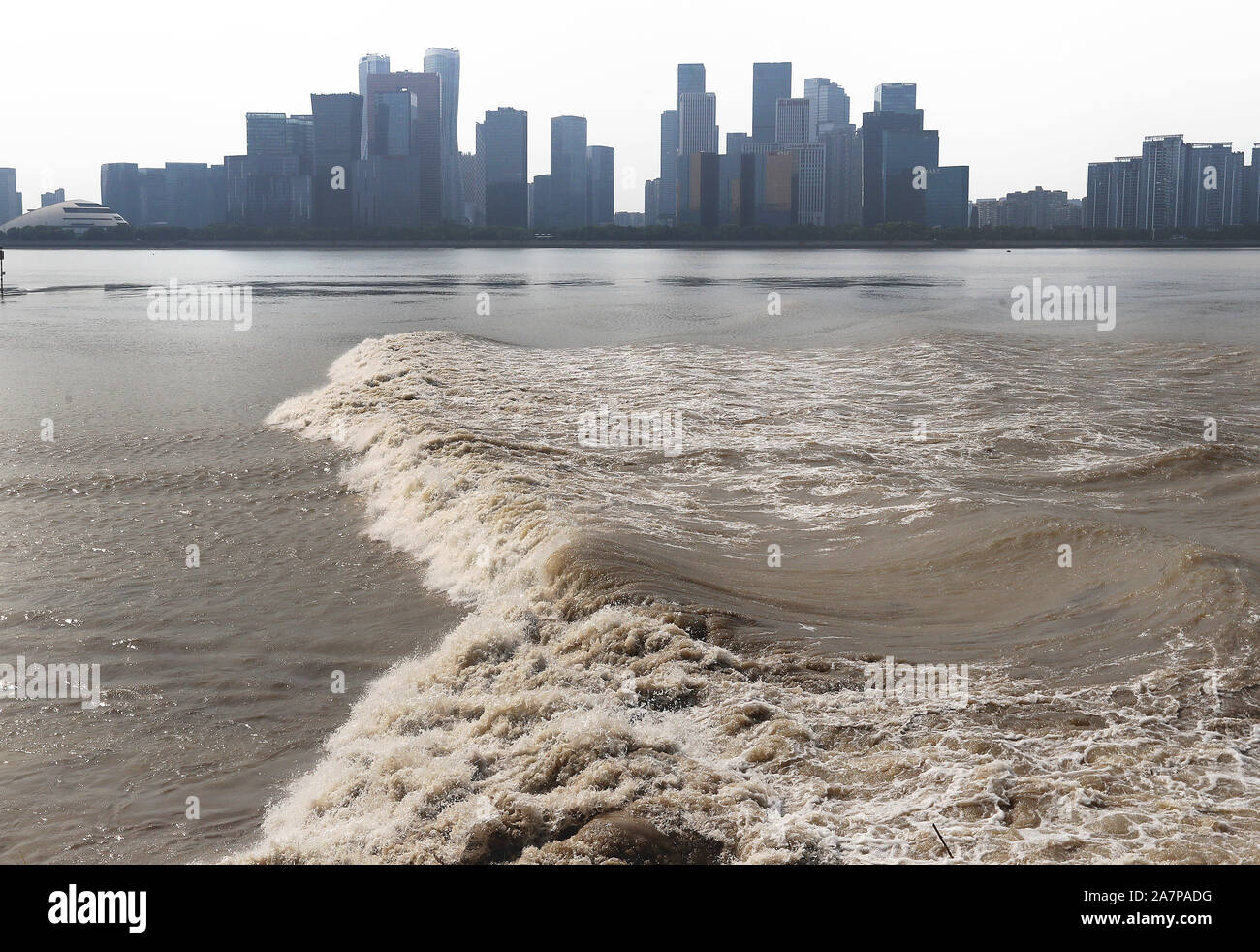 Visitors and local residents watch the tidal bore of the Qiantang River ...