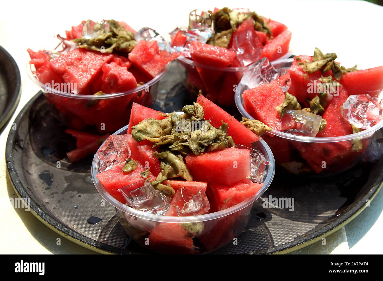 Bowls full of watermelon added with zhacai, or pickled mustard stems ...