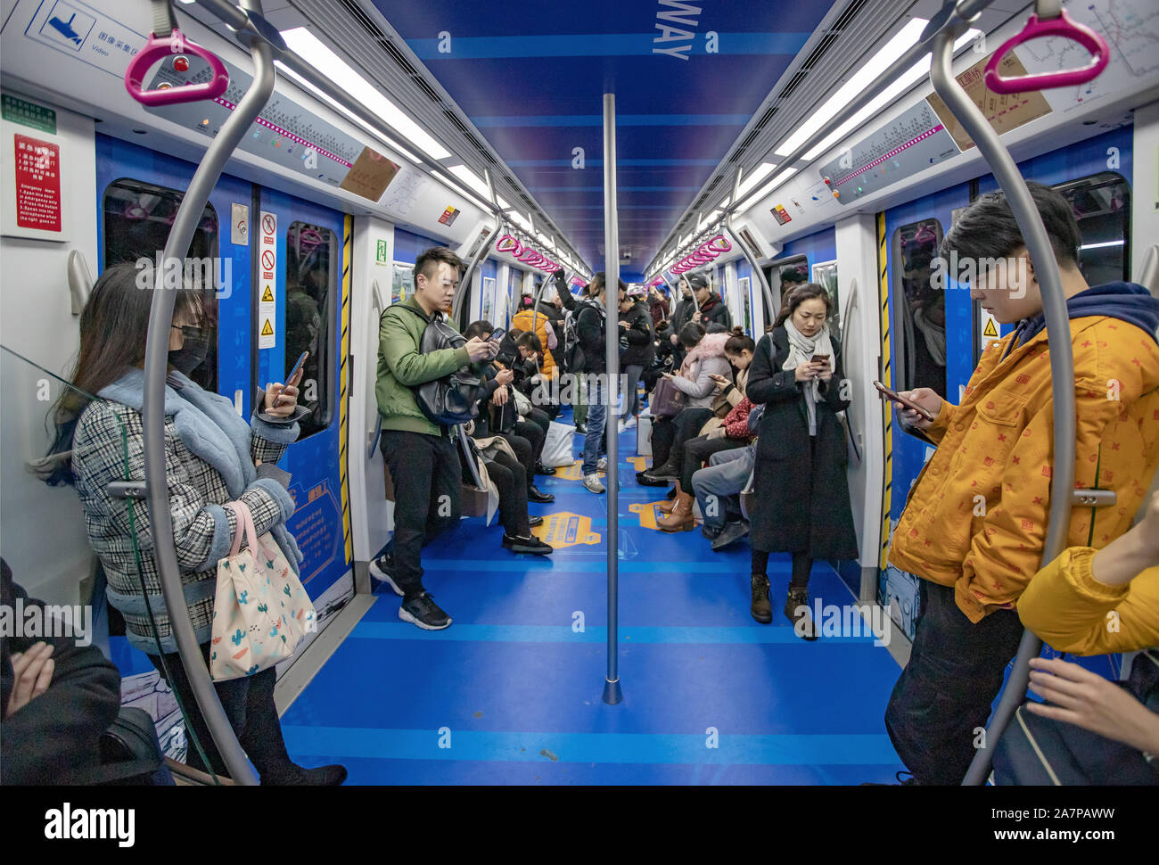 --FILE--Chinese passengers use their smartphones to surf the Internet ...