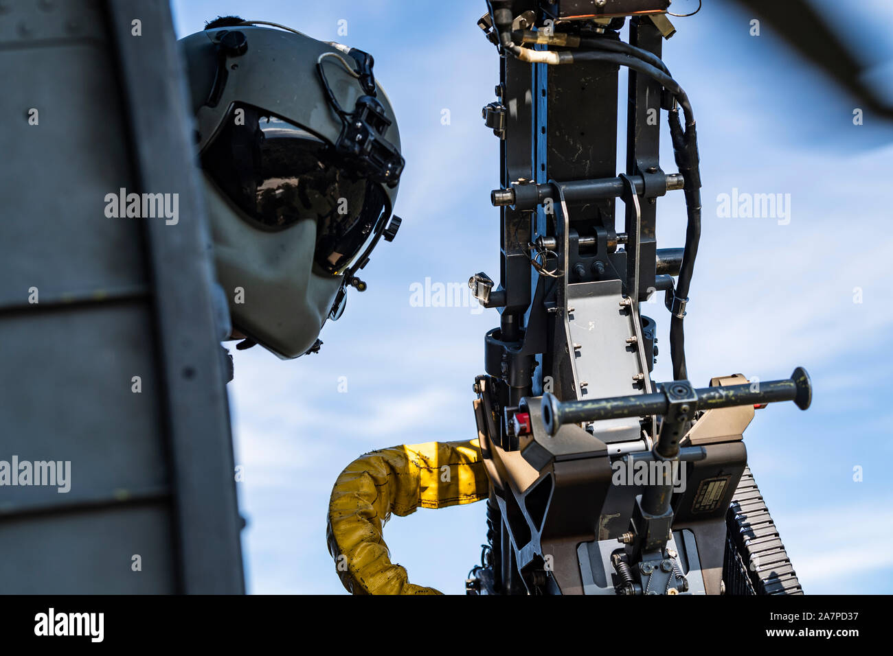 An Airman assigned to the 41st Rescue Squadron looks out of an HH-60G ...