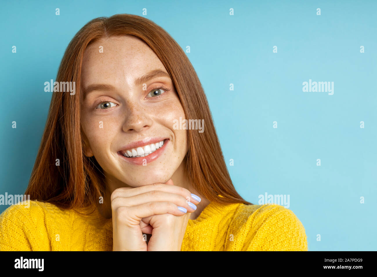 Indoor closeup portrait of beautiful cheerful ginger young woman with ...
