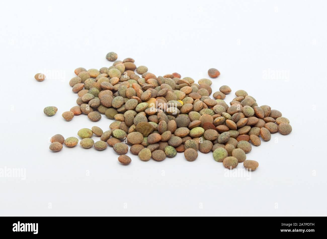 Brown lentils on an isolated white background Stock Photo - Alamy