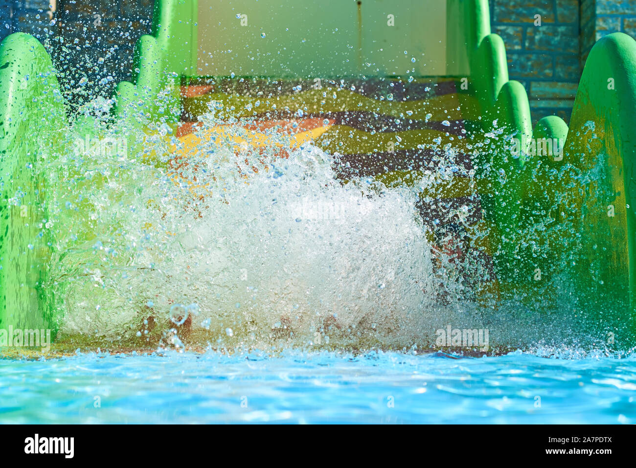Woman and two boys on water park slides. Happy family ride on water ...