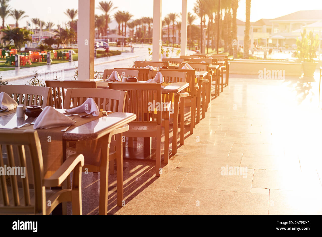Empty terrace with table and chairs outdoor in sunset Stock Photo - Alamy