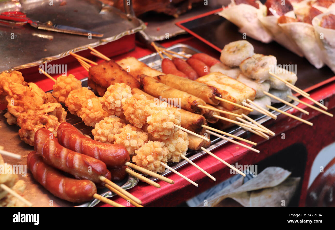 Traditional Chinese fast food on the sticks on street market Stock ...