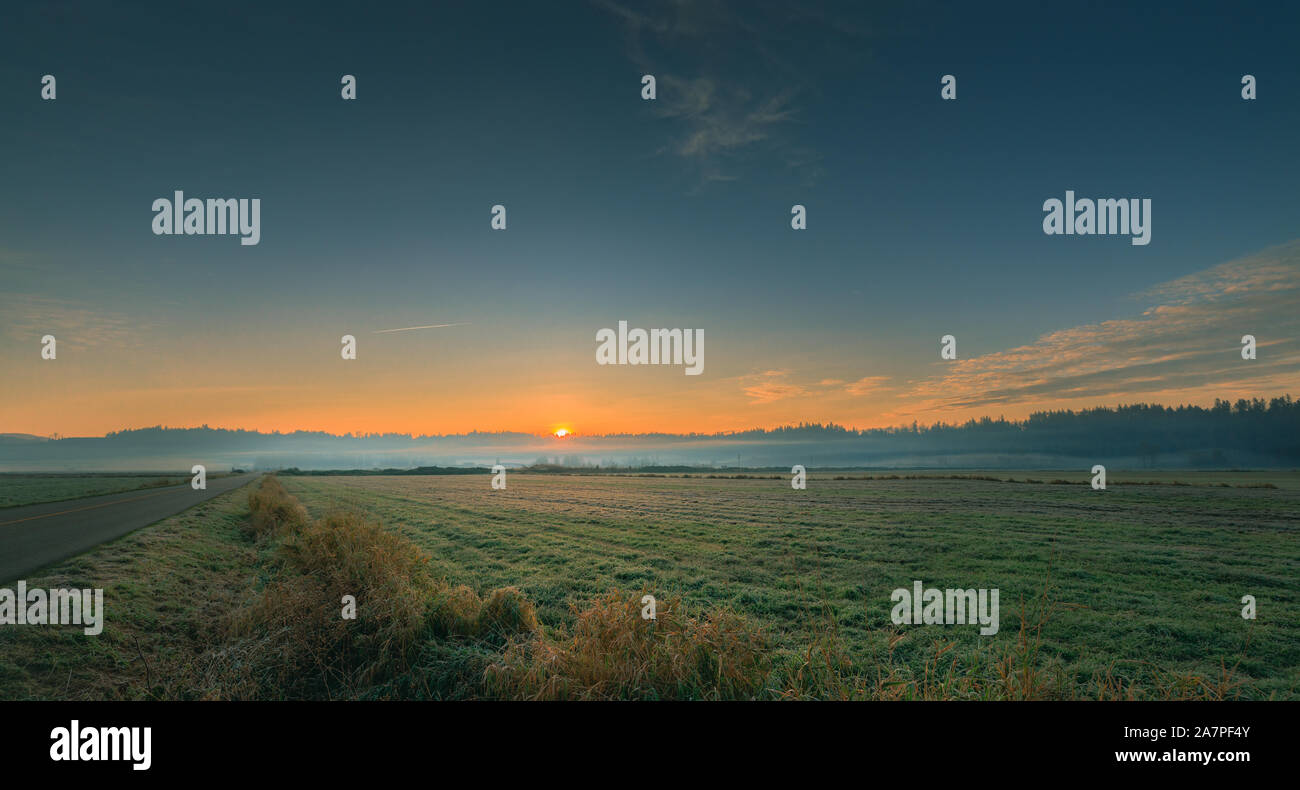 Beautiful November sunrise over farm field Stock Photo - Alamy