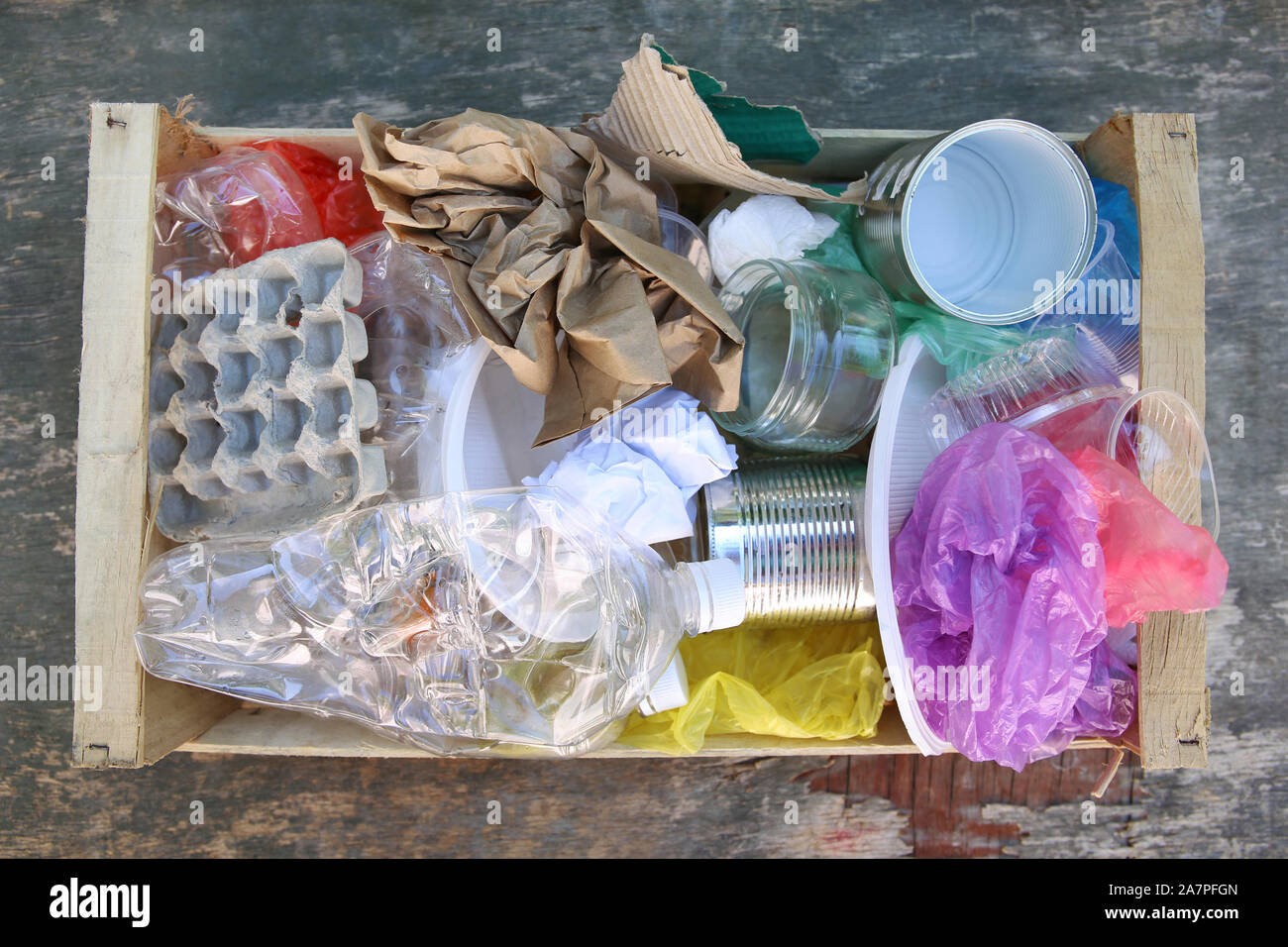 Box with trash on wooden background. Top view. Flat lay Stock Photo - Alamy