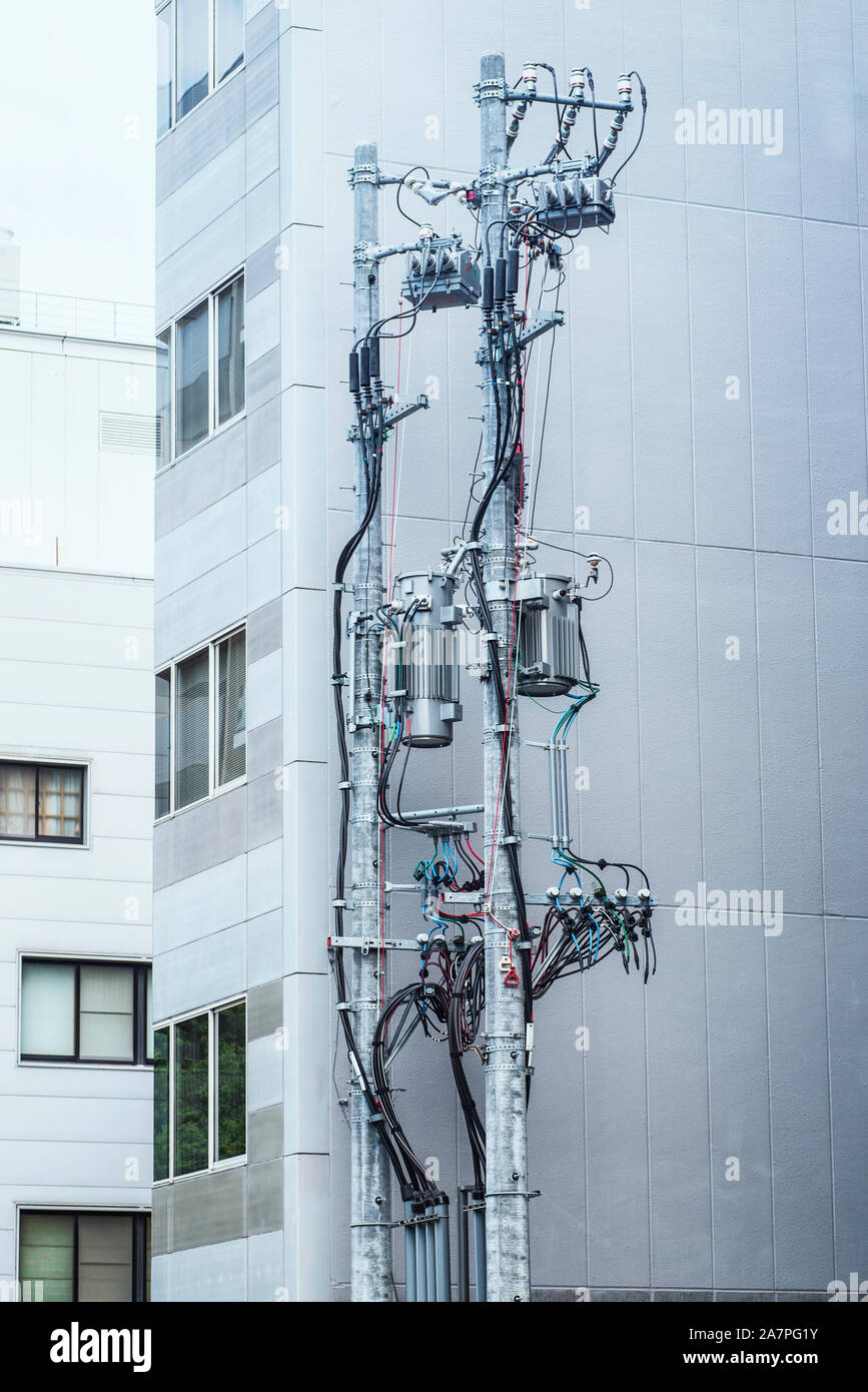 Modern poles with electricity cables on the background of a residential ...