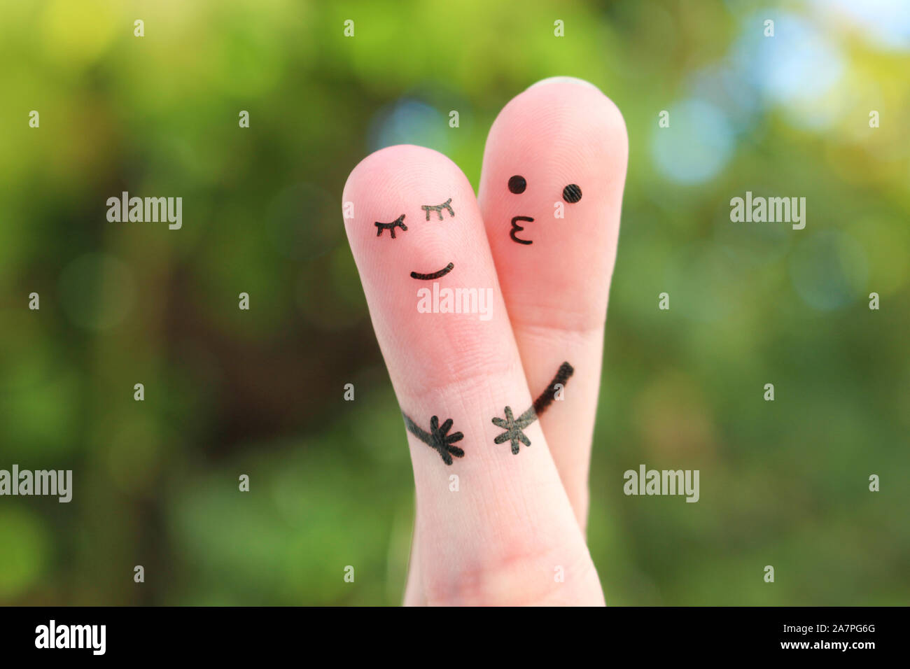 Fingers art of Happy couple. Man hugs and kisses woman Stock Photo - Alamy