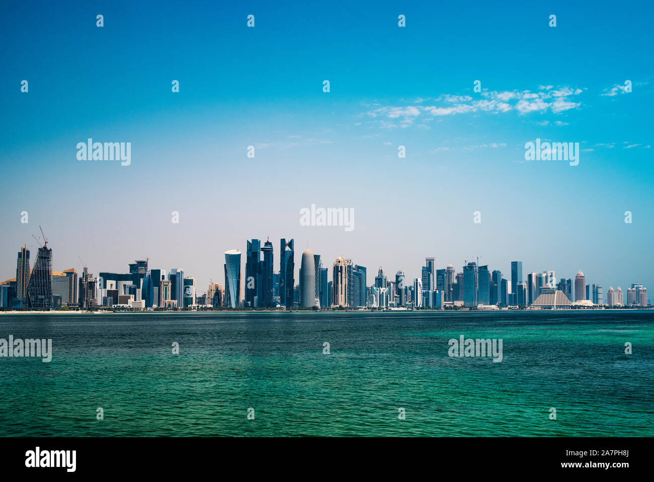 DOHA, QATAR - 4 AUGUST 2018: The modern city of Doha with palm tree ...