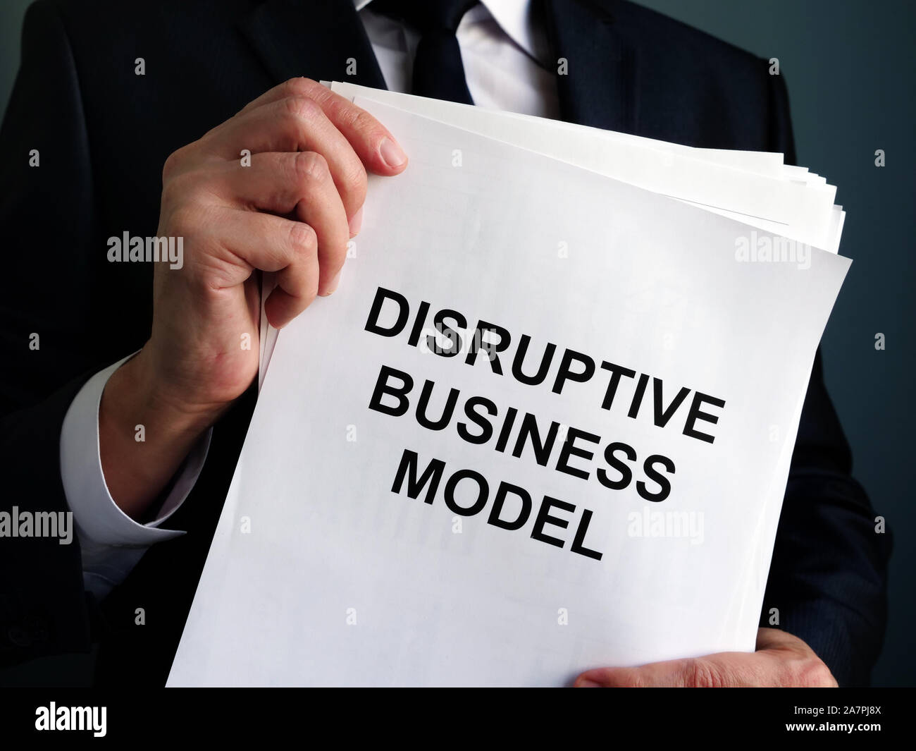 Manager is holding Disruptive Business Model report Stock Photo - Alamy