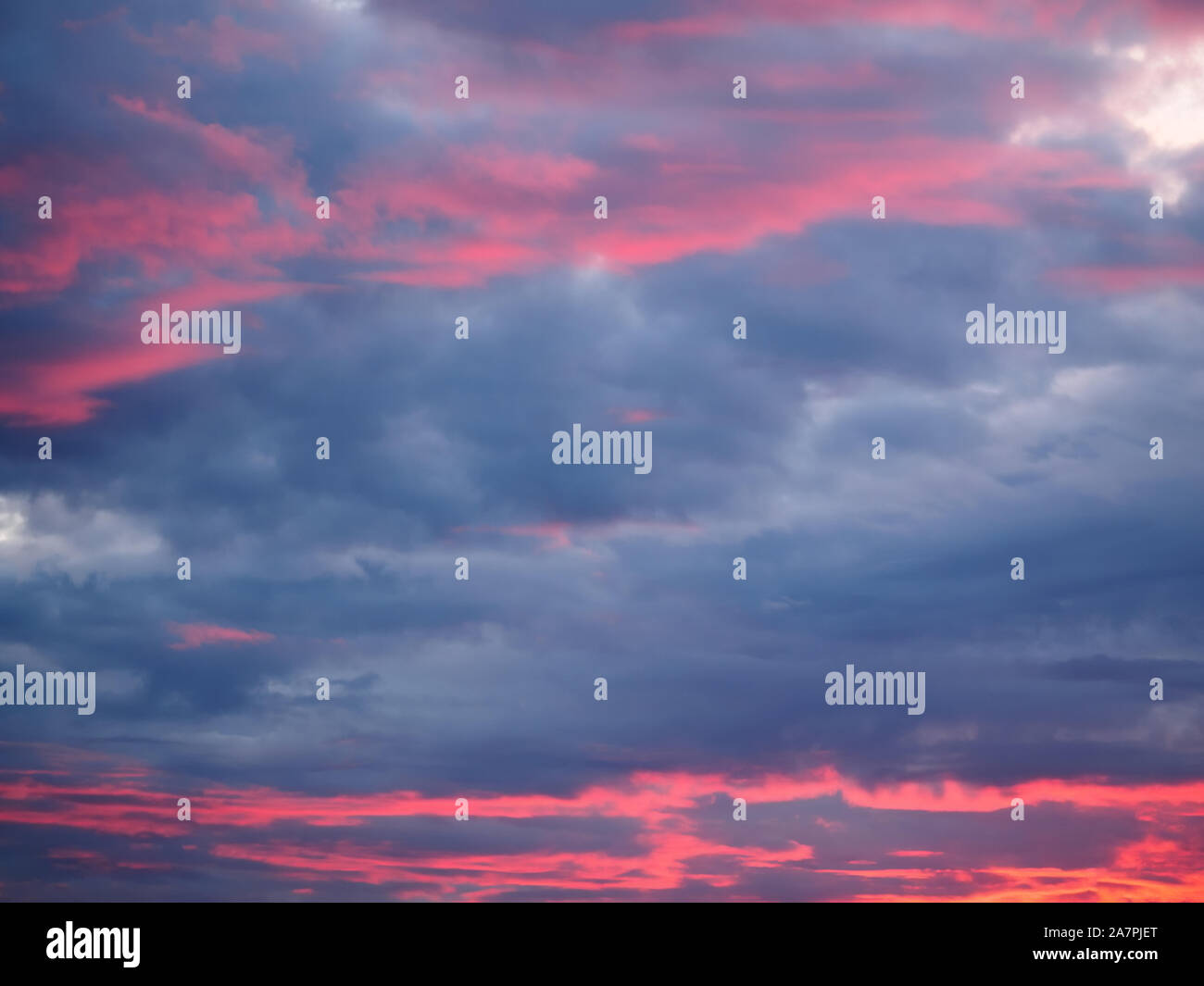 Thunderclouds on a sky background illuminated by the sun's rays of the ...