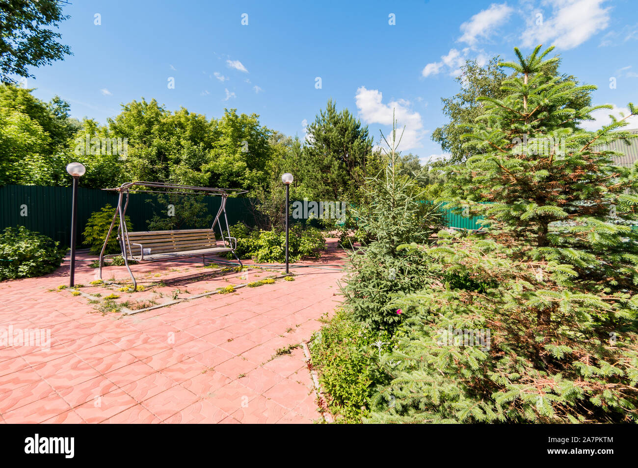 green recreation area in the courtyard of a private house, trees and ...