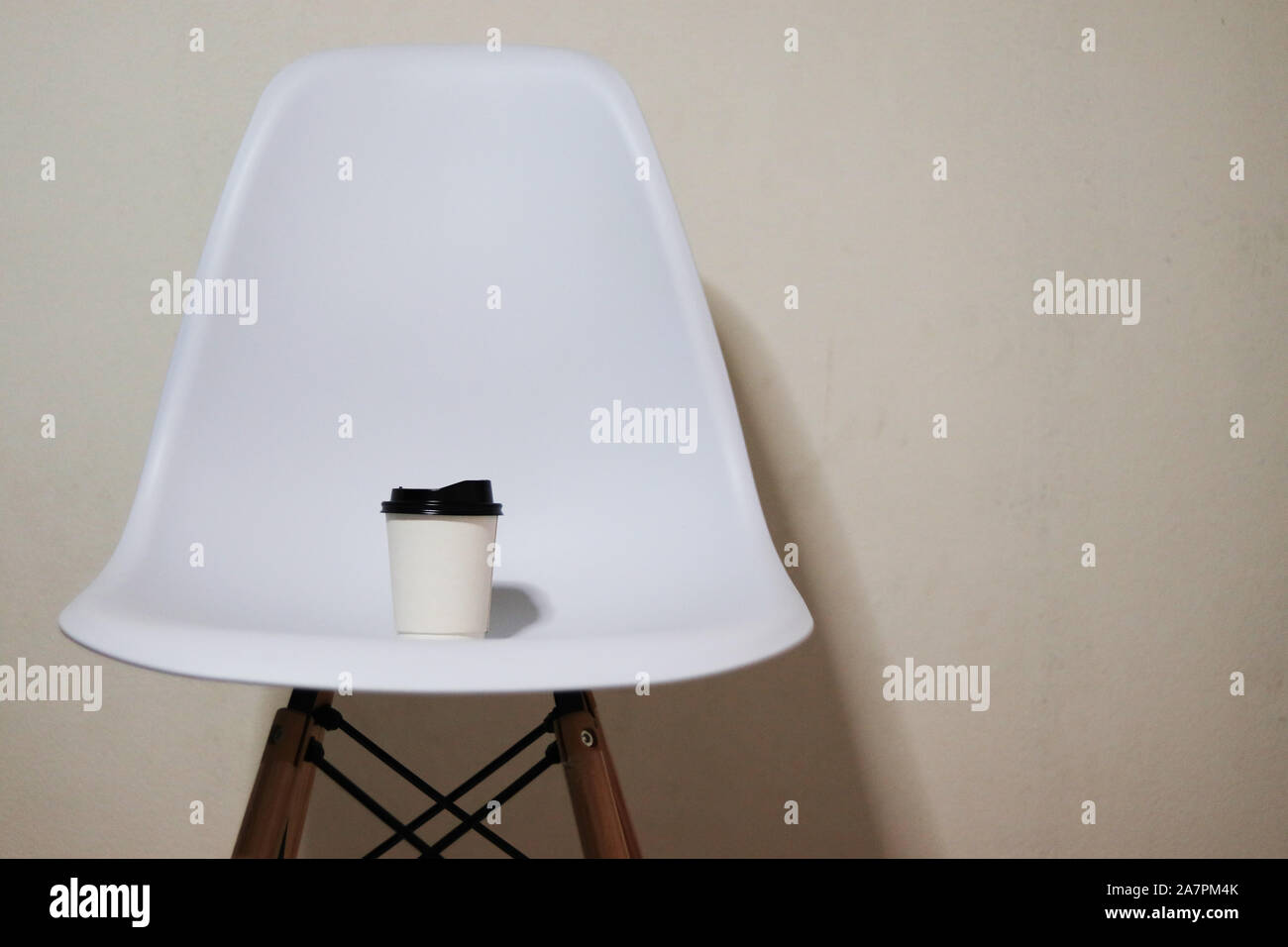 paper cup on the white chair Stock Photo - Alamy