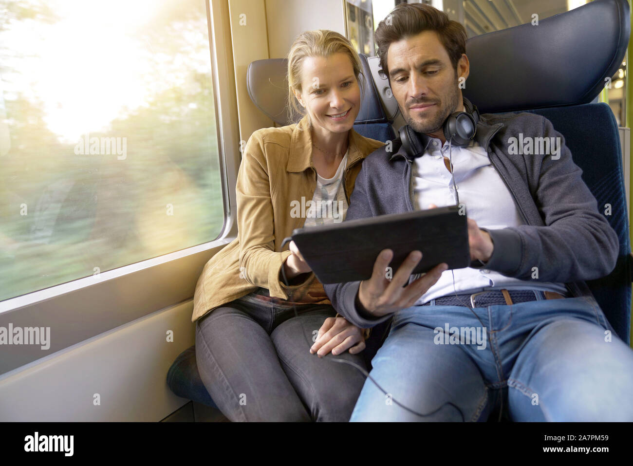 couple traveling in a train Stock Photo - Alamy